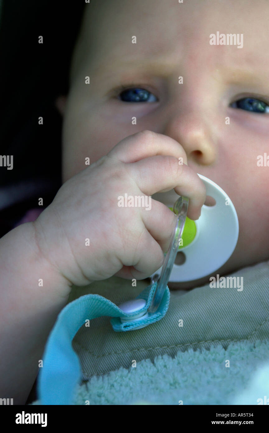 baby holding pacifier Stock Photo - Alamy