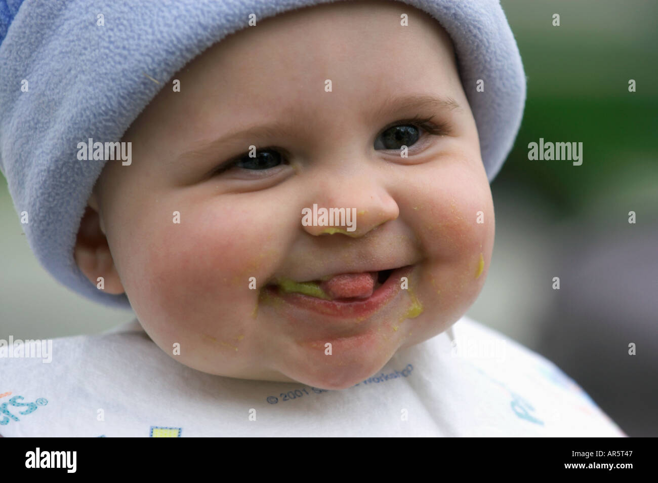 smiling baby with food on face Stock Photo - Alamy