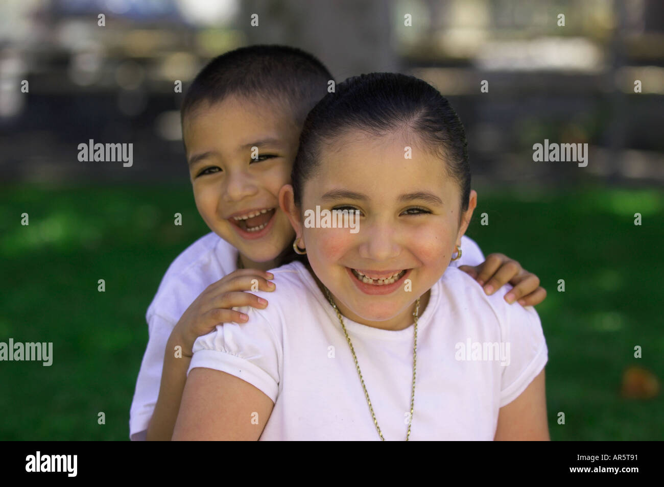 Hispanic kids hug friends hi-res stock photography and images - Alamy