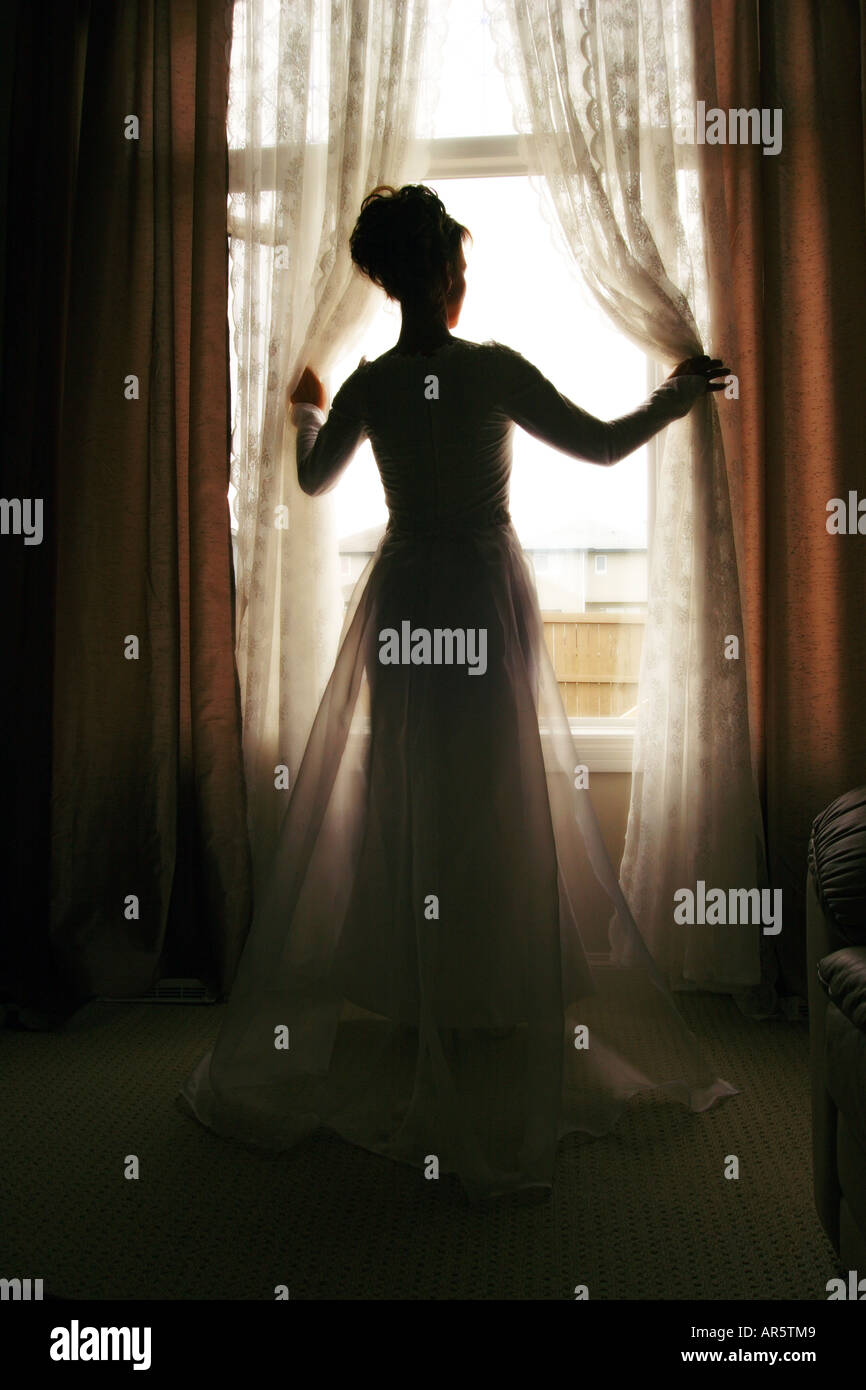 Bride looking out window Stock Photo - Alamy