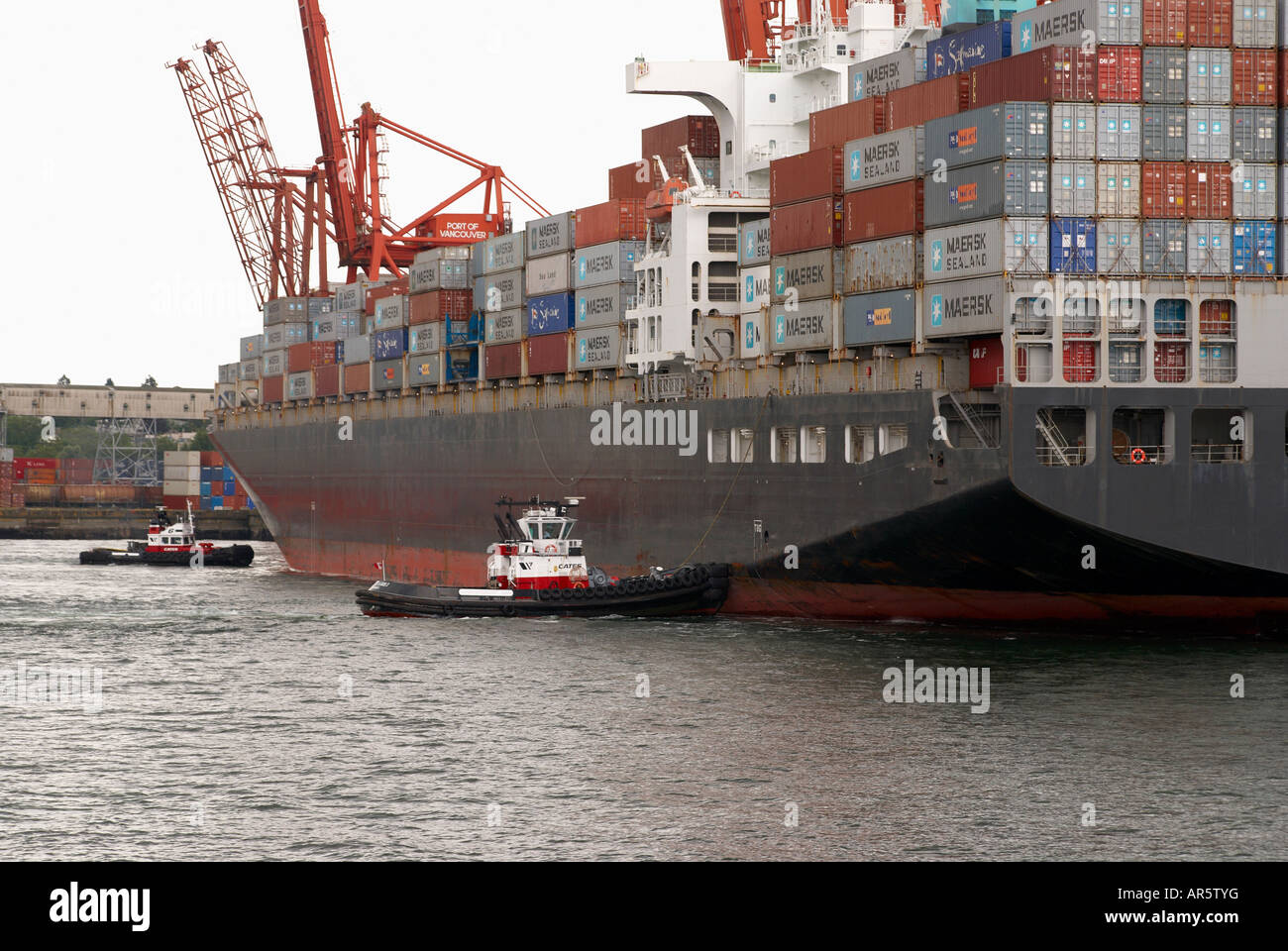 Tugs assisting a container ship onto a berth at the Vancouver container ...