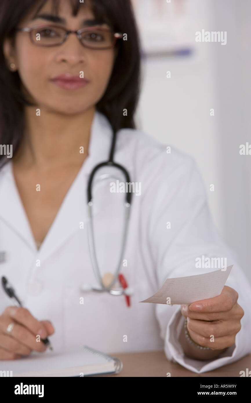 Female doctor handing over prescription hi-res stock photography and ...