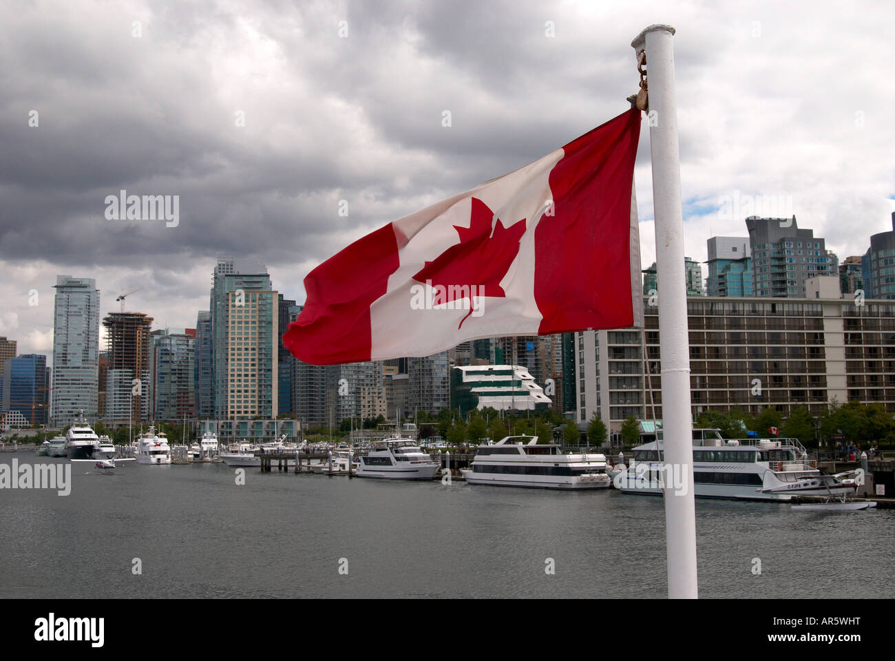 Canadian flag on stern of a harbour cruise tour boat with downtown ...