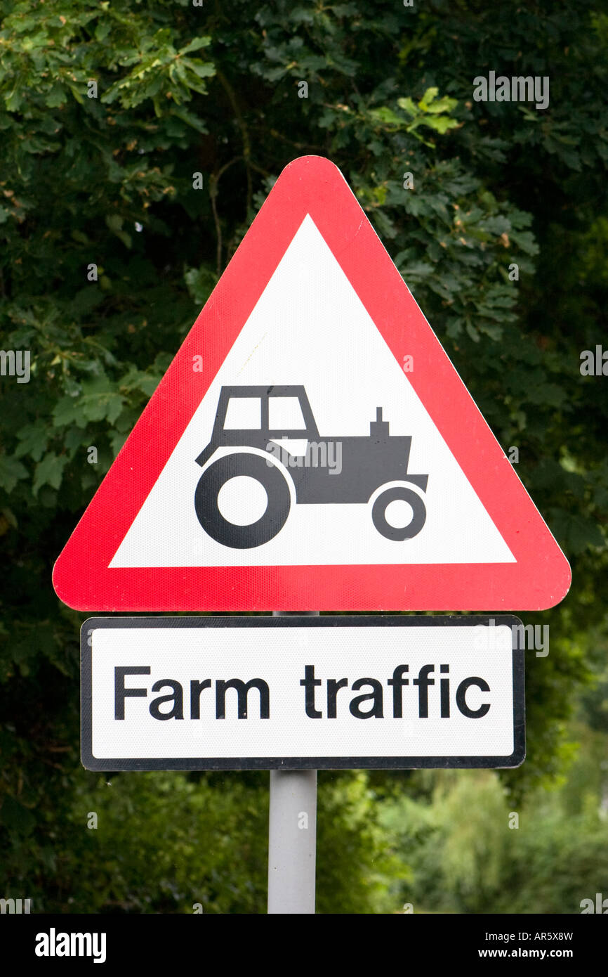 Caution farm traffic road sign Stock Photo - Alamy