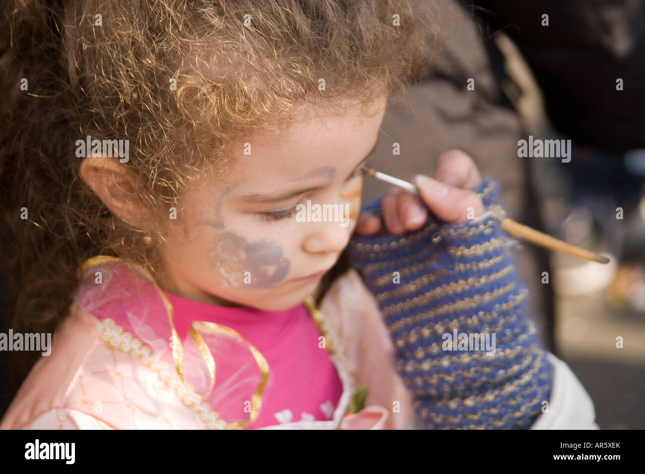 Girl having her face painted at the Carnival in Venice, Italy Stock ...