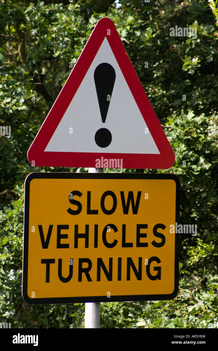 Caution slow vehicles turning road sign Stock Photo - Alamy