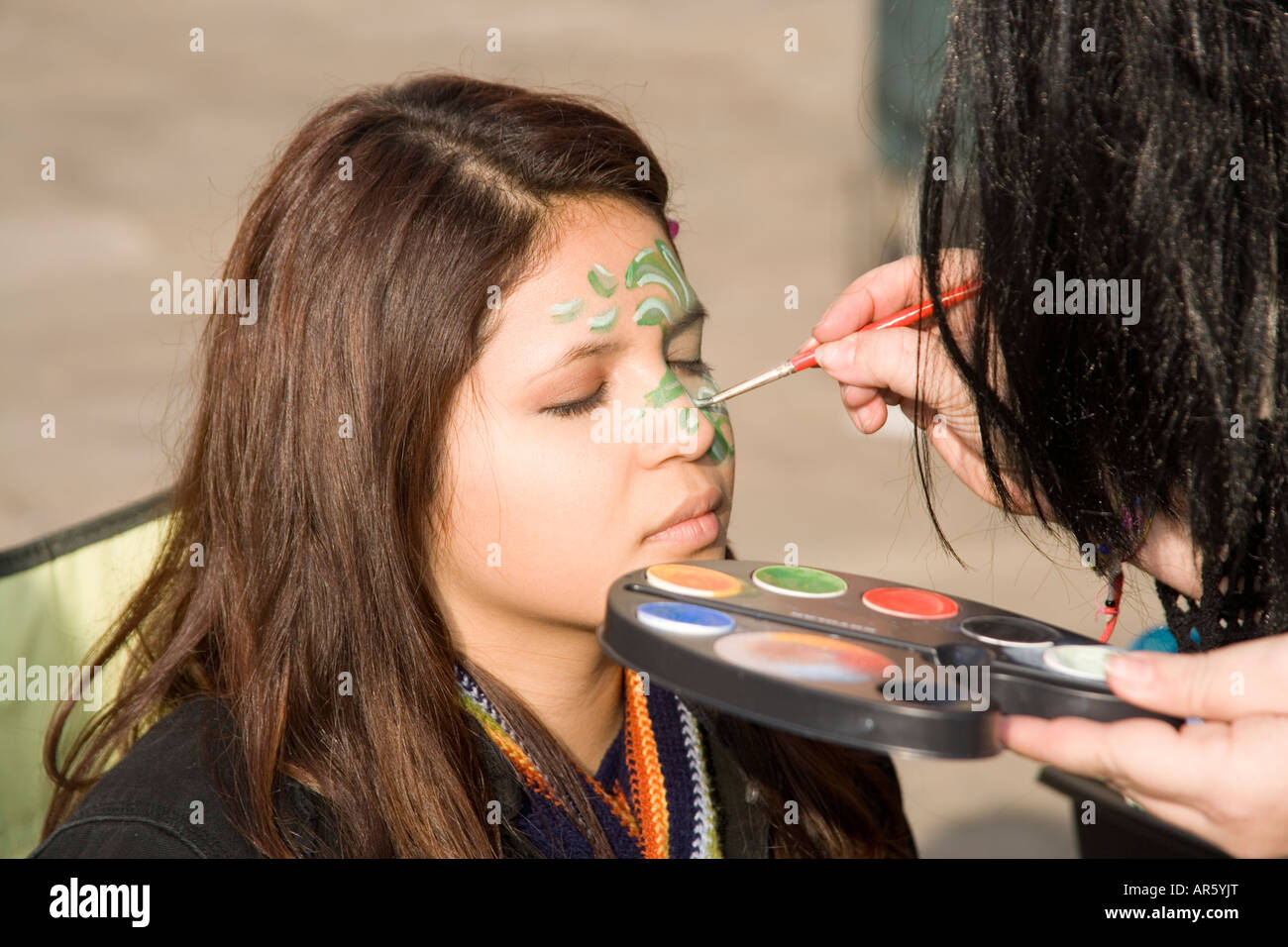 Girl having her face painted at the Carnival in Venice, Italy Stock ...