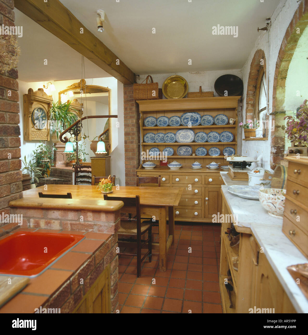 Red sink in seventies fitted pine kitchen dining room with wooden ...