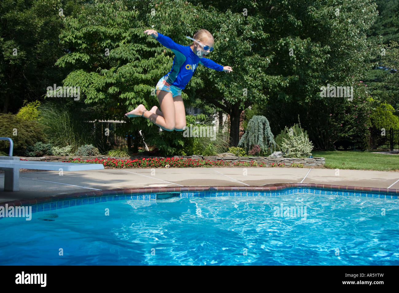 Child jumping into a swimming pool Stock Photo - Alamy