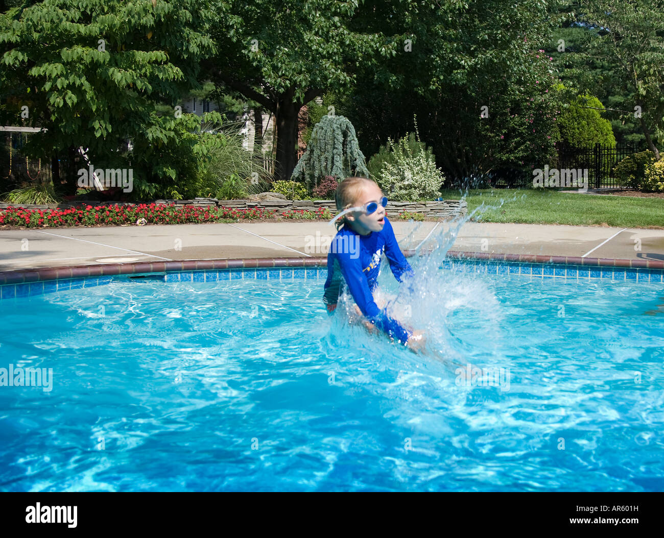 Child jumping into a swimming pool Stock Photo - Alamy