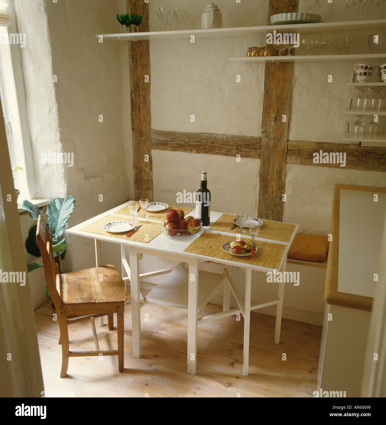 Wooden chair and white table in seventies economy kitchen dining room ...