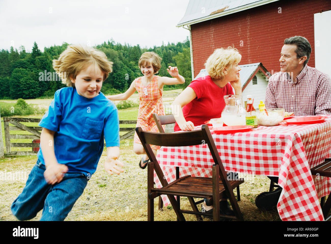 Family eating outdoors on farm Stock Photo - Alamy