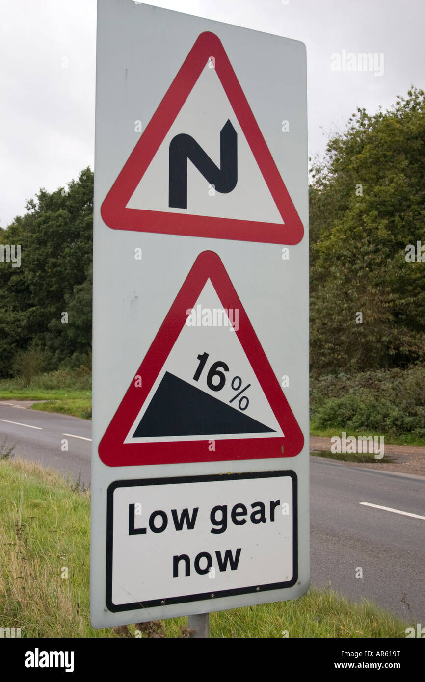 caution steep hill and bends in road road sign Stock Photo - Alamy