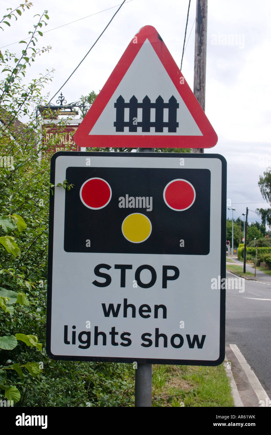 Beware automatic barriers at level crossing road sign Stock Photo - Alamy