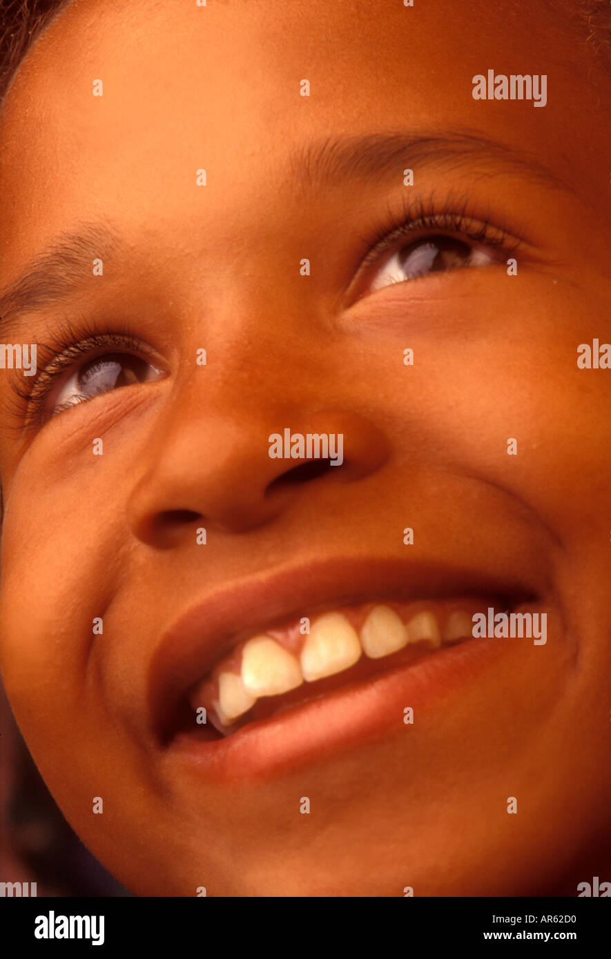 Close up on face of teenage Afro Caribbean boy smiling Stock Photo - Alamy