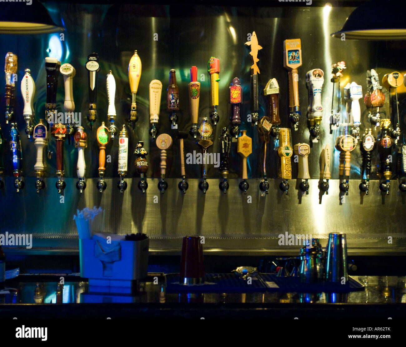 Multiple beer taps behind the bar Stock Photo - Alamy