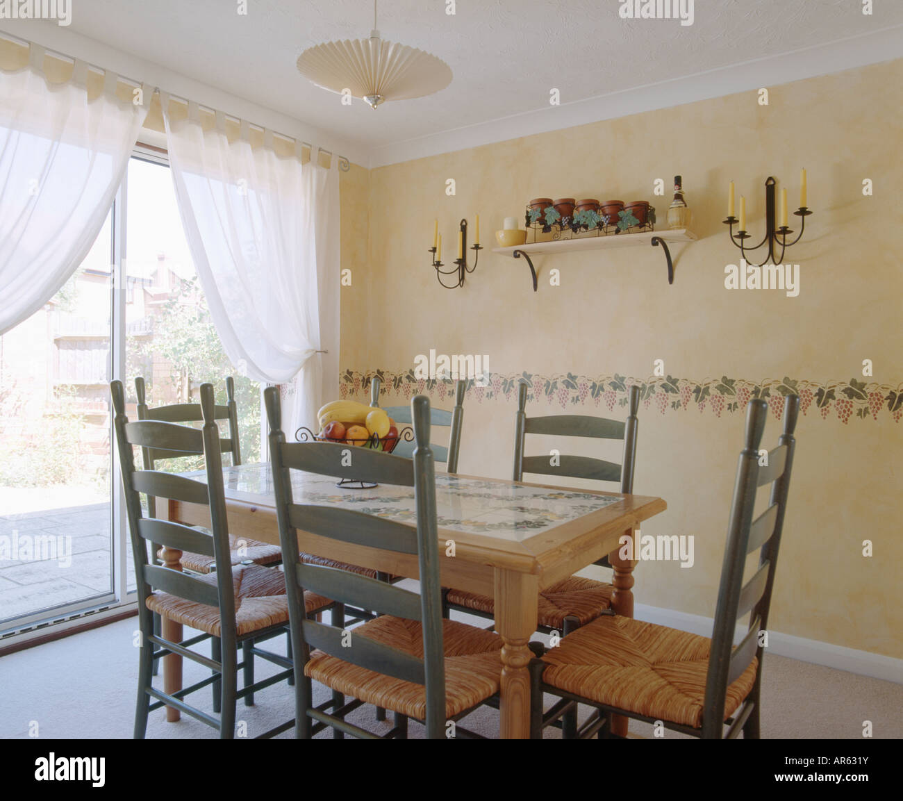 Rush seated green ladderback chairs in dining room with paint effect ...