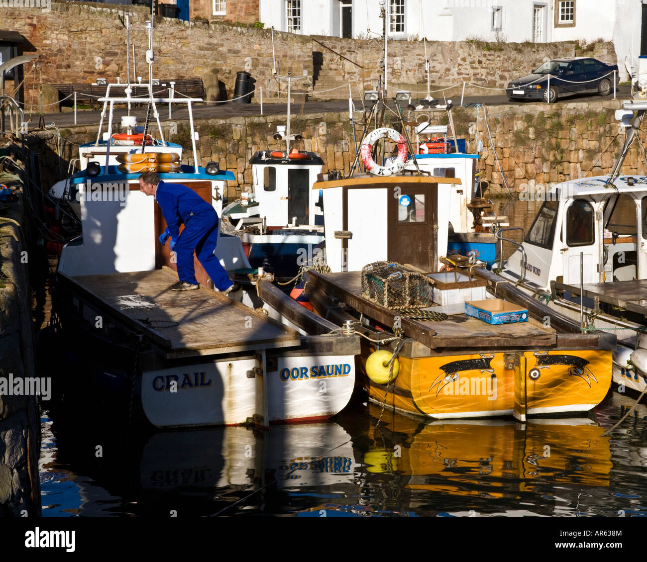 A fisherman working at Crail harbour, East Neuk of Fife, Scotland Stock ...