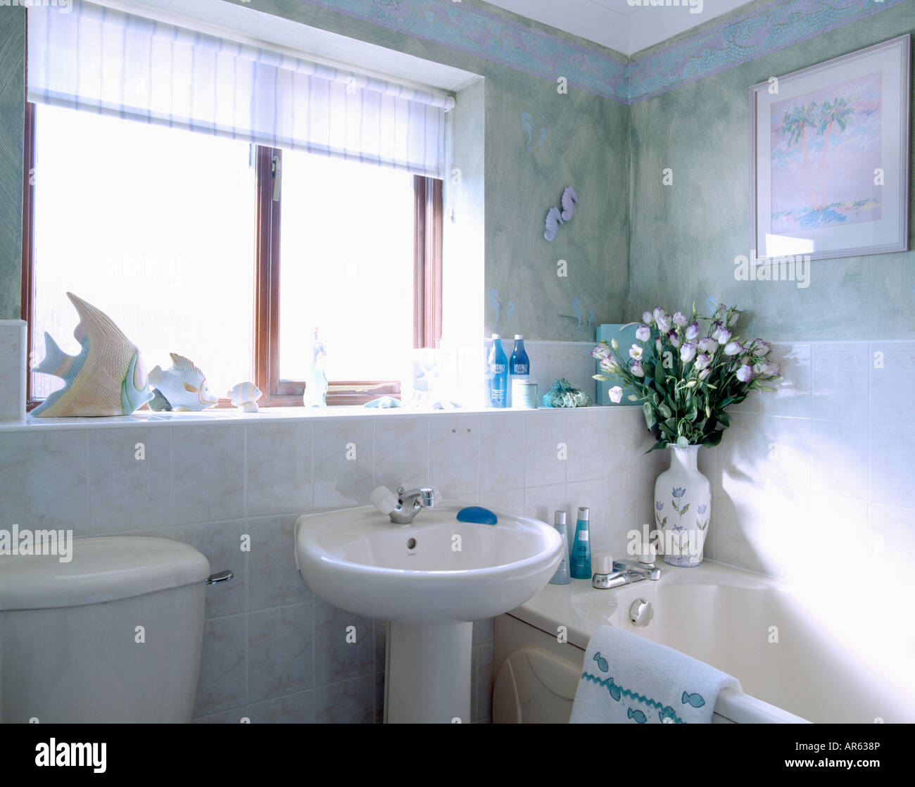 Small pastel turquoise bathroom with ragging paint effect walls Stock ...