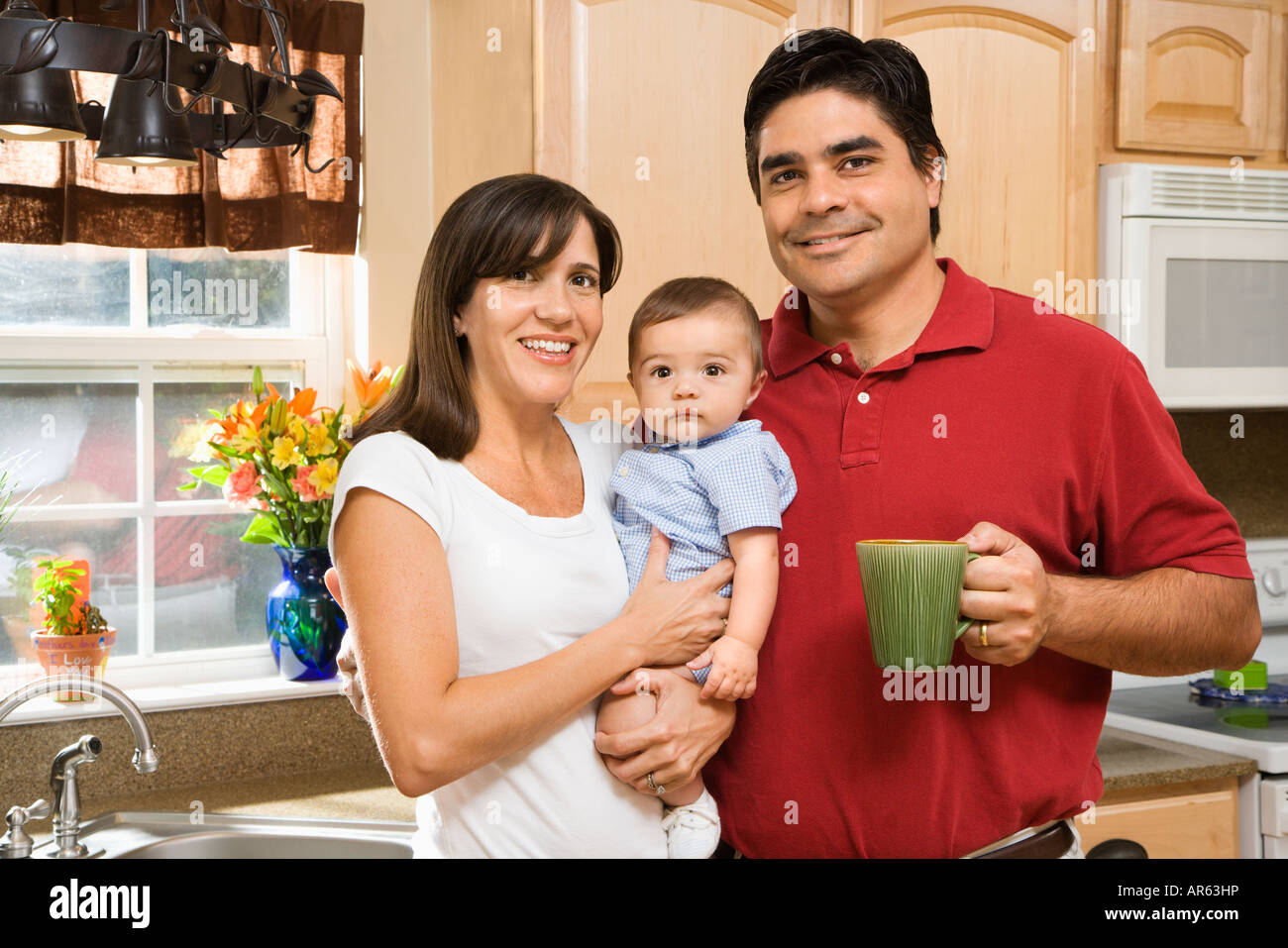 Hispanic family portrait in home kitchen with baby Stock Photo - Alamy
