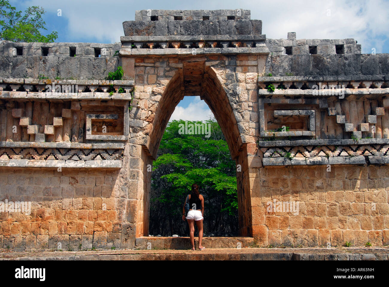 Female tourist crossing the arch in Labna, Yucatan State, Mexico, North ...