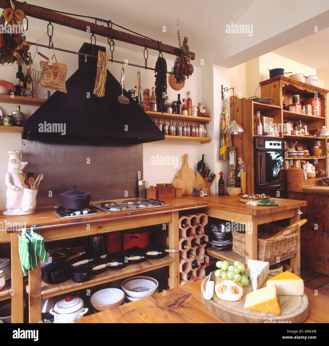 Extractor hood and hanging rack above hob and shelving in traditional ...