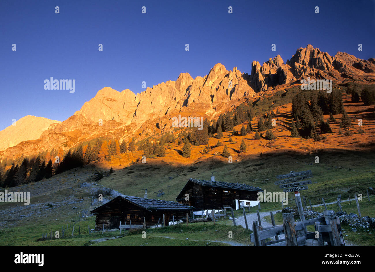 traditional alpine hut with shingle roof in front of Hochkoenig range ...
