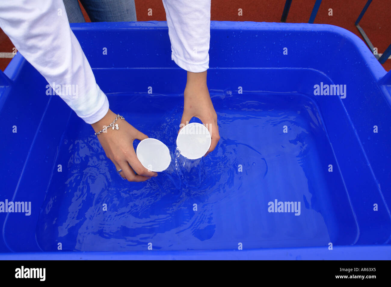 Filling up cup of water Stock Photo - Alamy