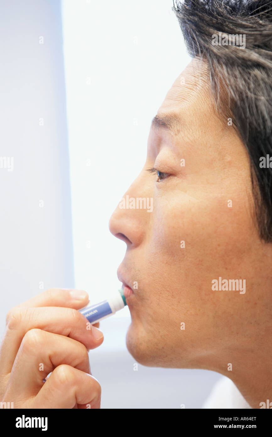 Man applying lip balm hi-res stock photography and images - Alamy