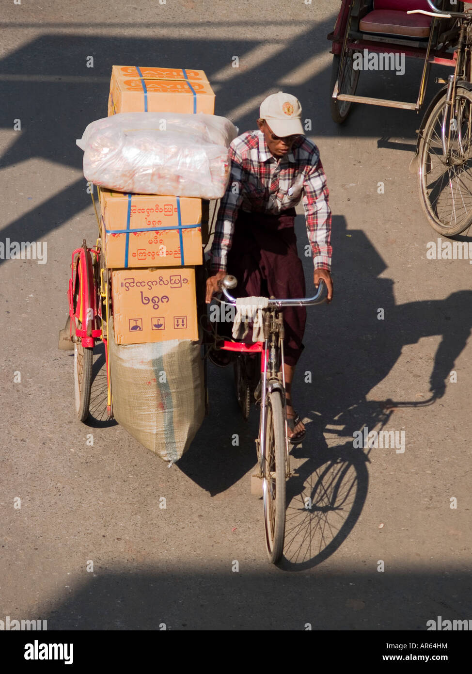 loaded rickshaw pedalling through Mandalay Stock Photo - Alamy