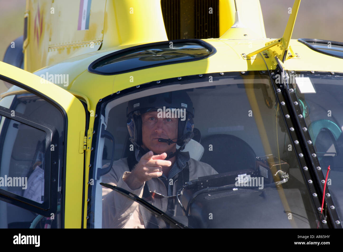 pilot in helicopter working flying eurocopter AS350 Stock Photo - Alamy