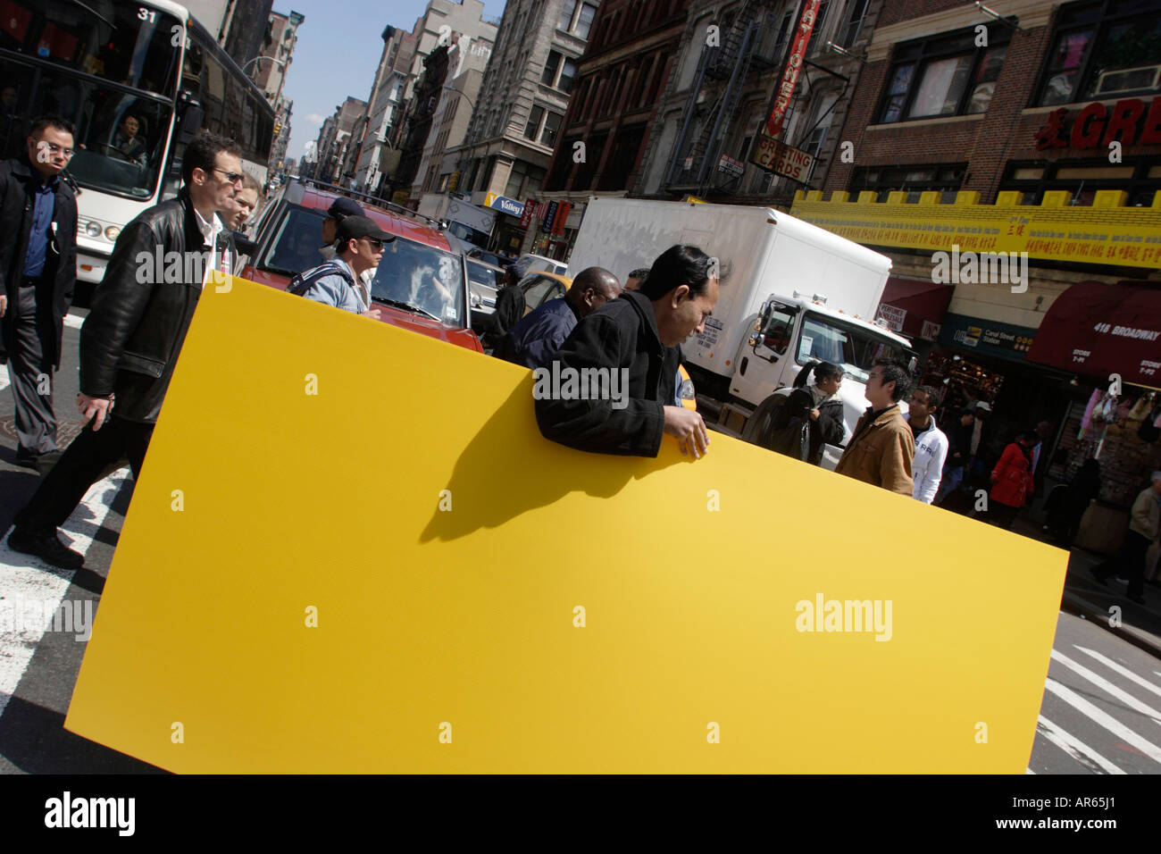 Man carrying yellow board, Canal Street, Trebeca, Chinatown, Manhattan ...