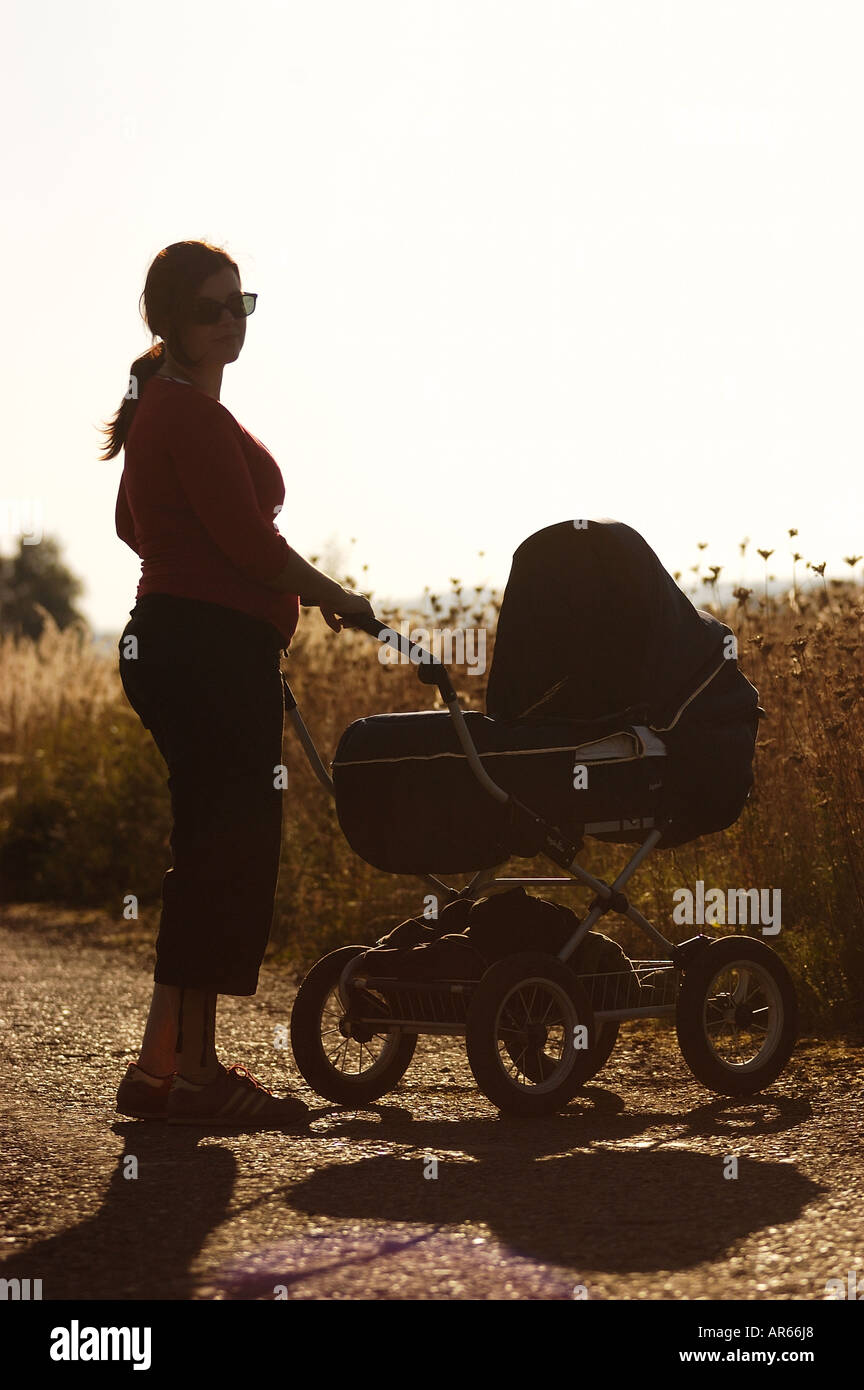 Portrait of a young woman pushing a baby pram on the trip Stock Photo ...