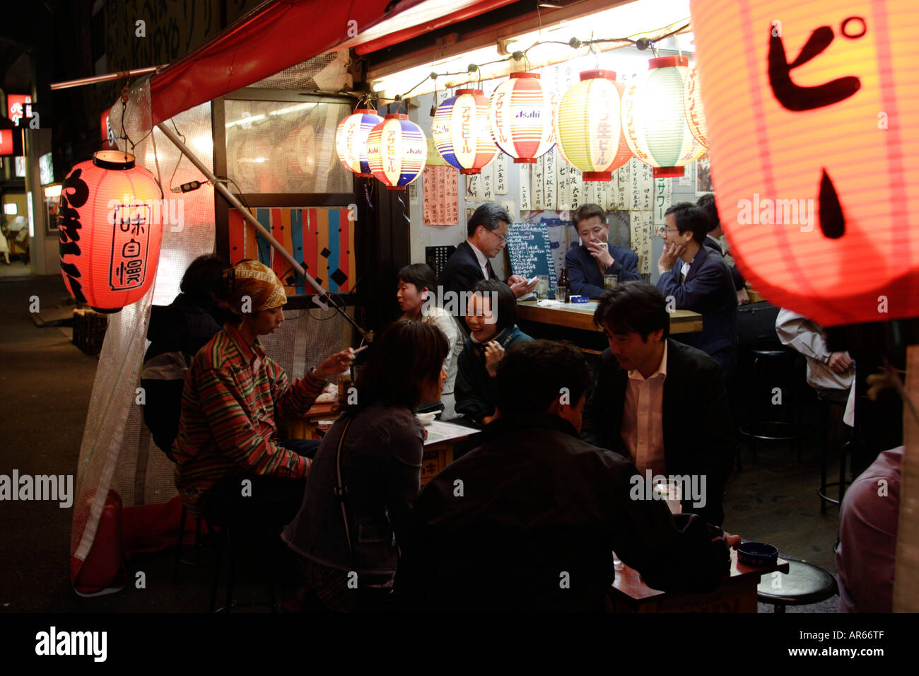 People sitting at a fast food at night, Yurakucho Yakitori Alley, Ginza ...