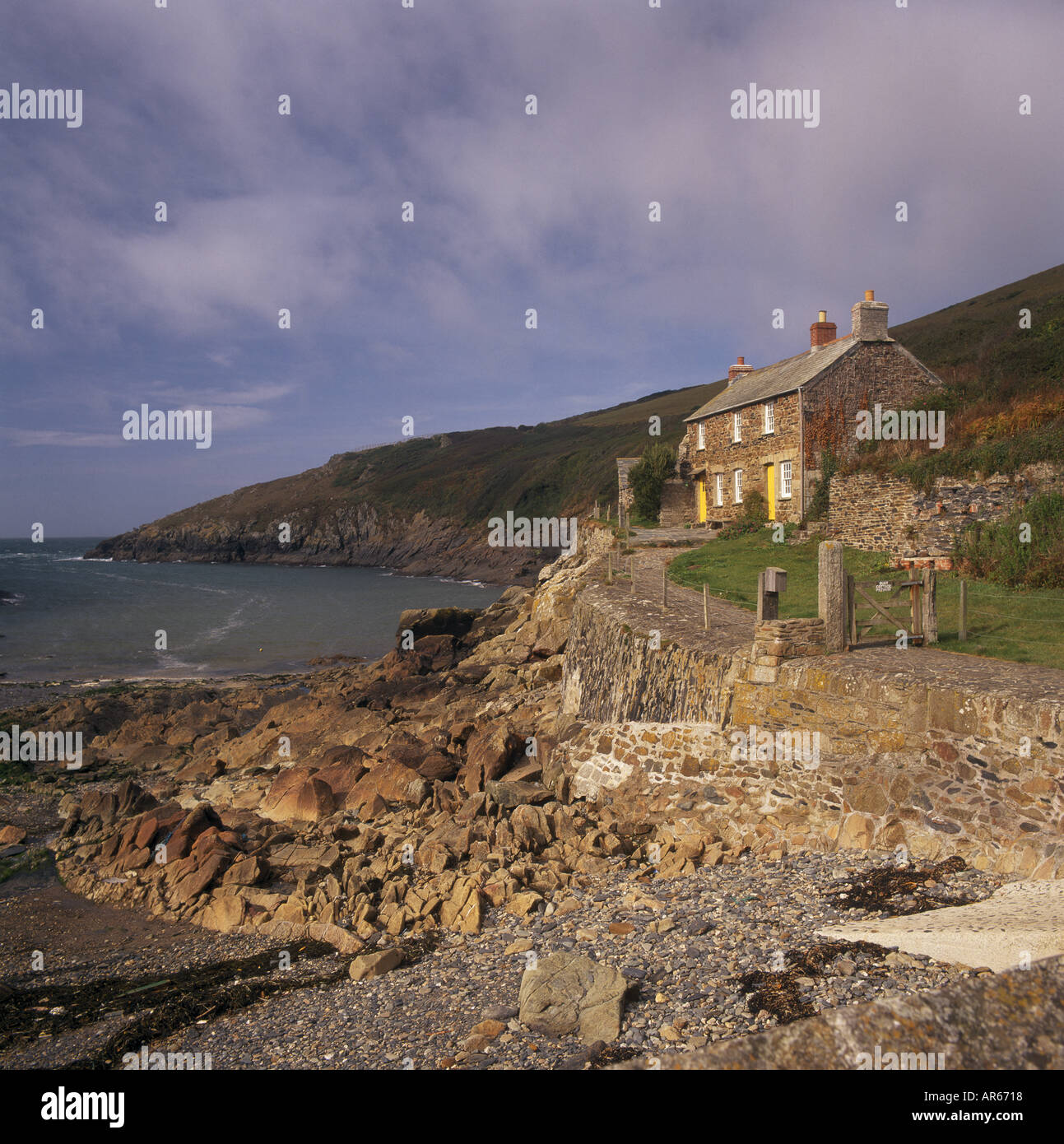 Quay Cottage a stone building sitting on the edge of a rocky foreshore ...