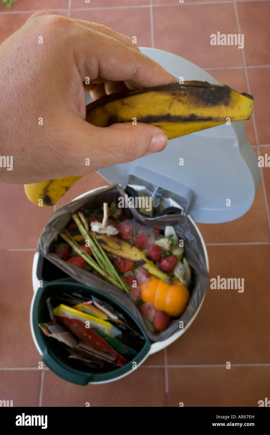 Throwing Organic garbage residues from a domestic recycling waste bin ...