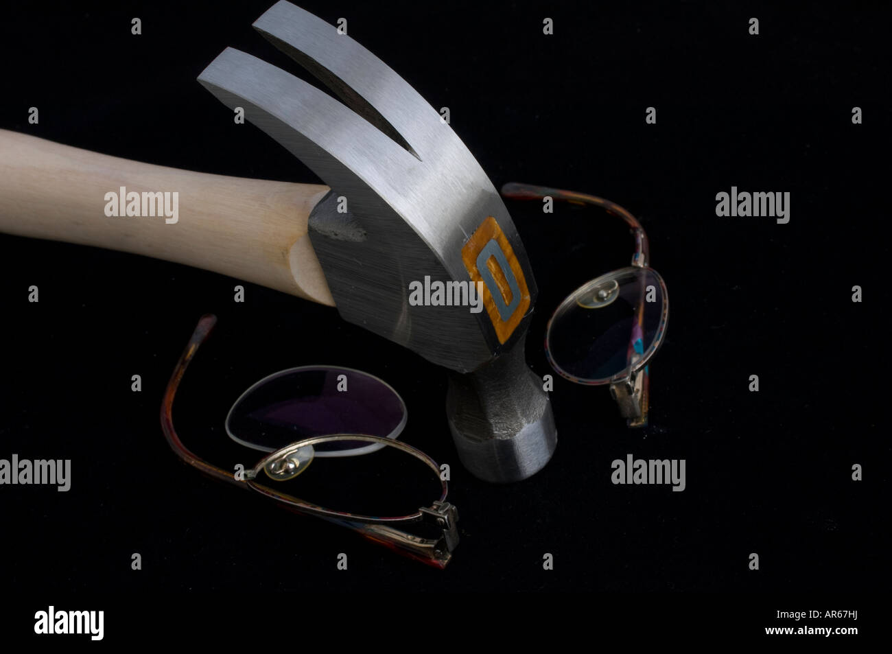 Hammer breaking spectacles Stock Photo - Alamy