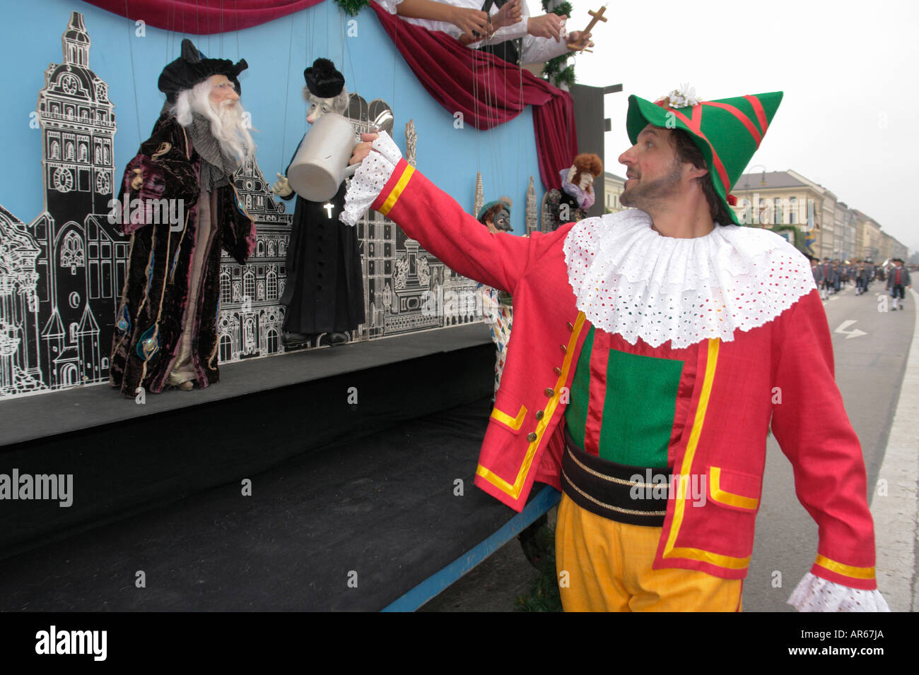 Clown feed puppet beer to drink Oktoberfest in Munich Bavaria Germany ...