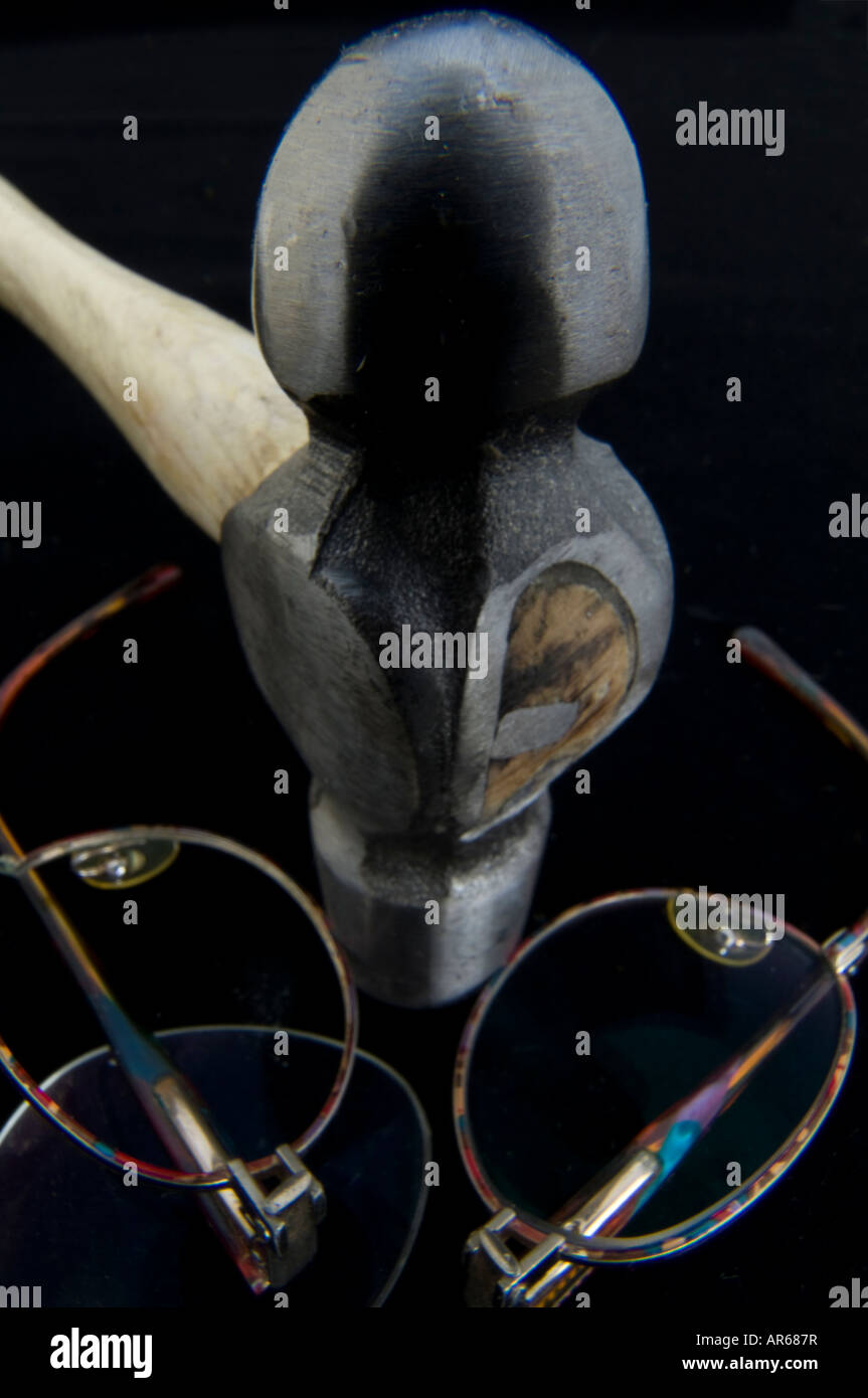 Hammer breaking spectacles Stock Photo - Alamy