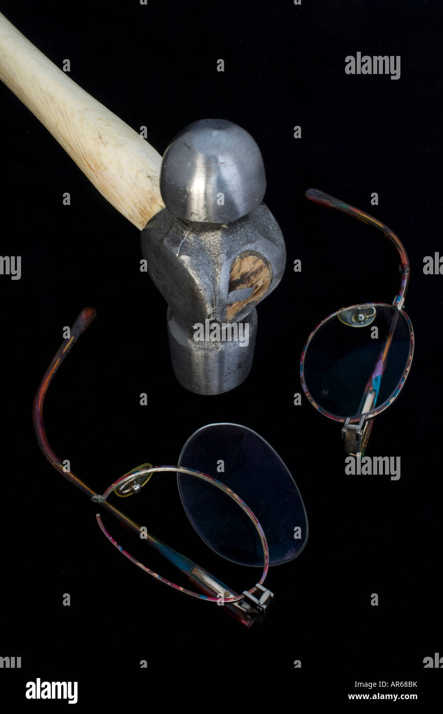 Hammer breaking spectacles Stock Photo - Alamy