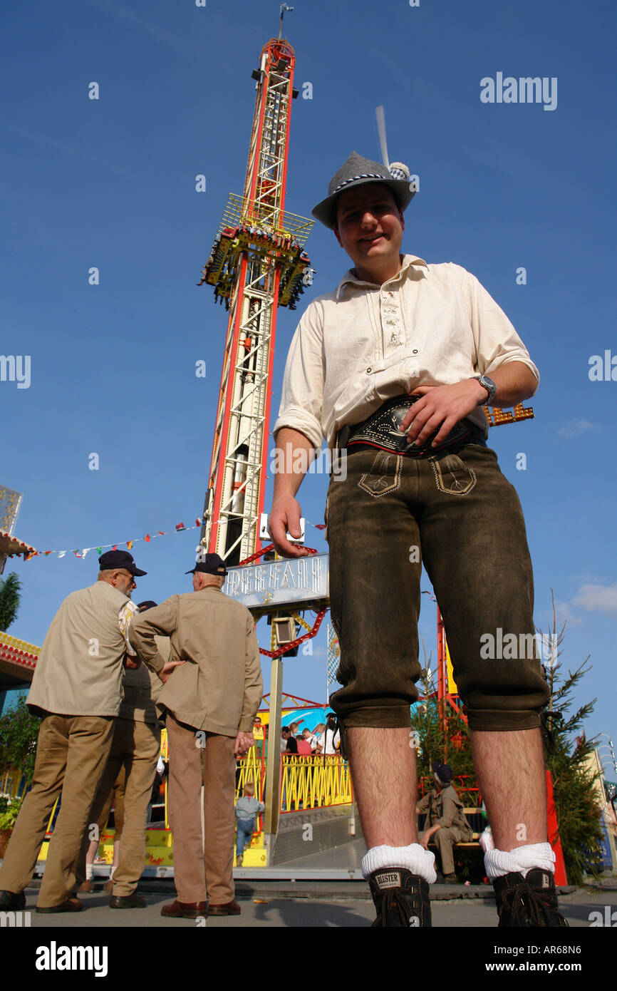 Man in Lederhosen watching Free fall machine game Oktoberfest in ...