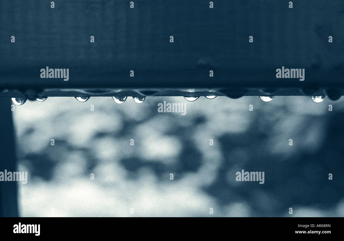 Drops of rain hanging off a park bench Stock Photo - Alamy