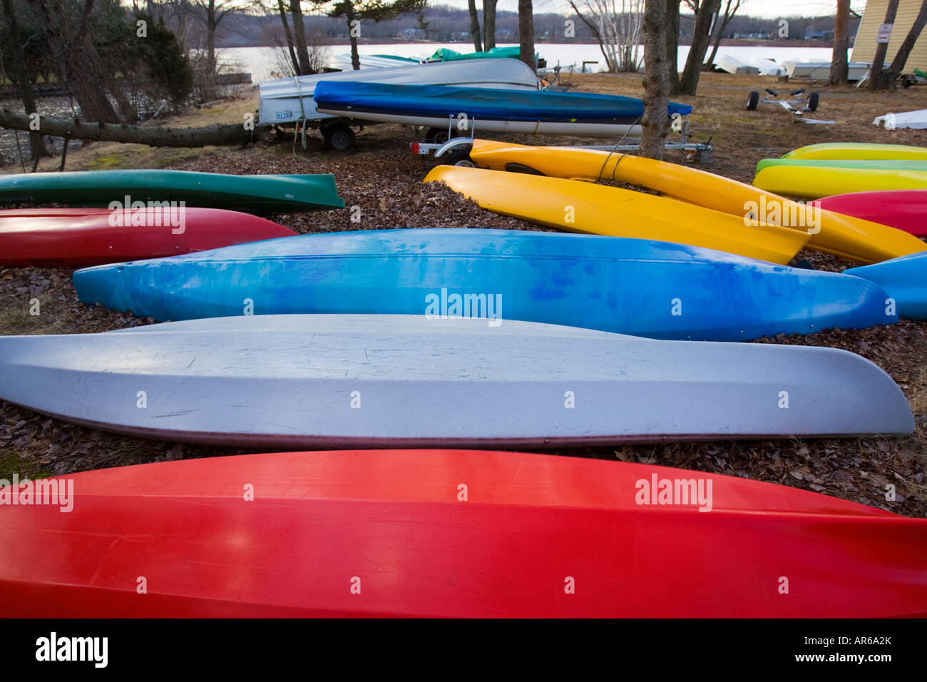 Canoes and kayaks by the side of a lake Stock Photo - Alamy