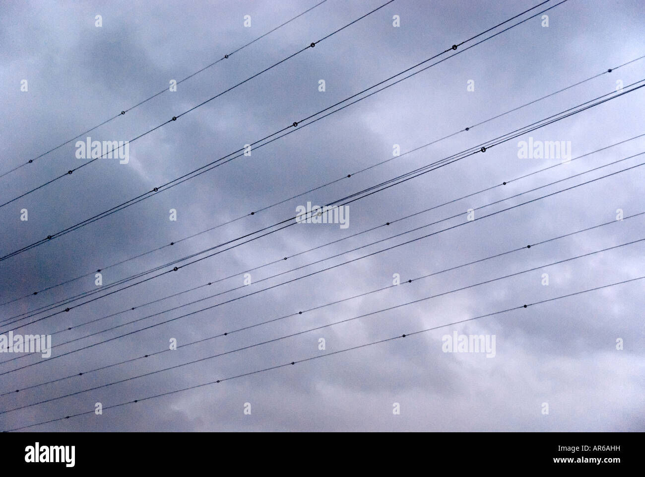 electric pylon cable across a deep dark blue sky Stock Photo - Alamy