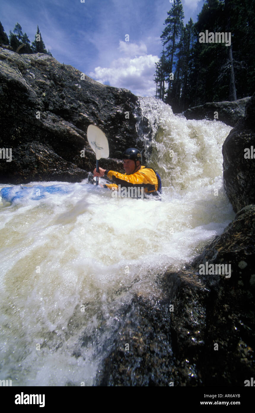 Whitewater kayaker paddling down a river Stock Photo - Alamy