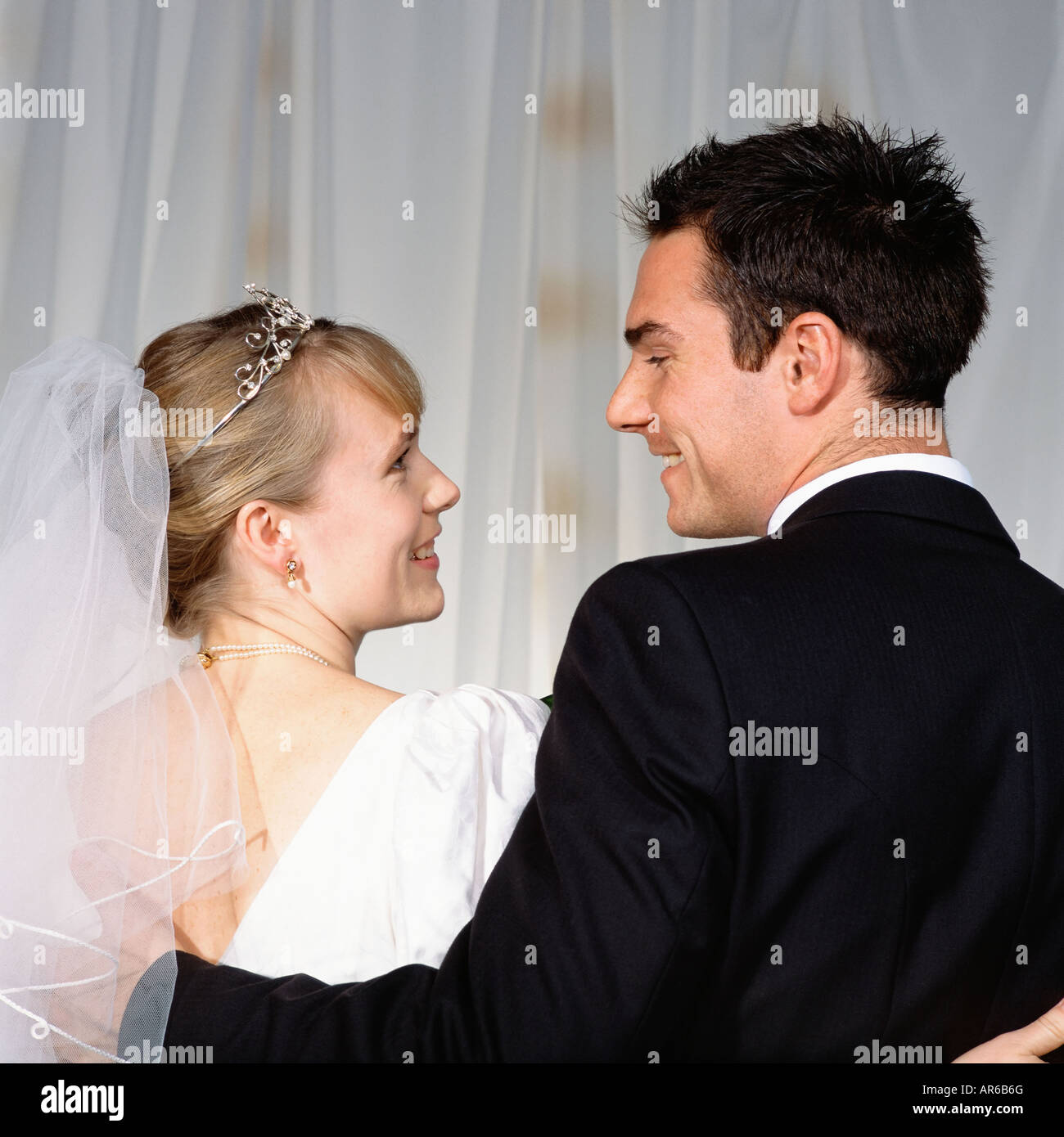 Bride and groom look at each other Stock Photo - Alamy