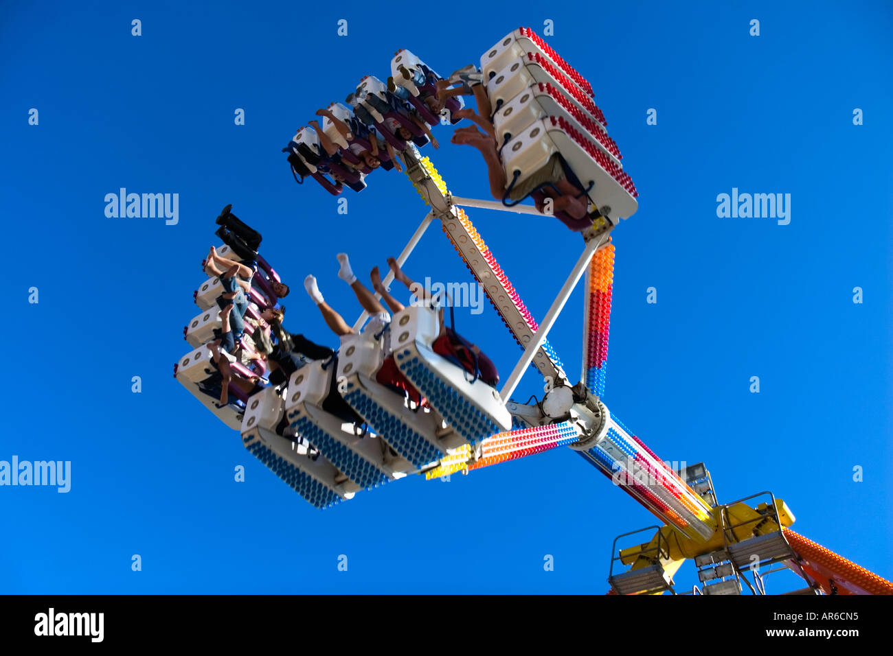 Children enjoying a fairground ride being spun on the end of a ...
