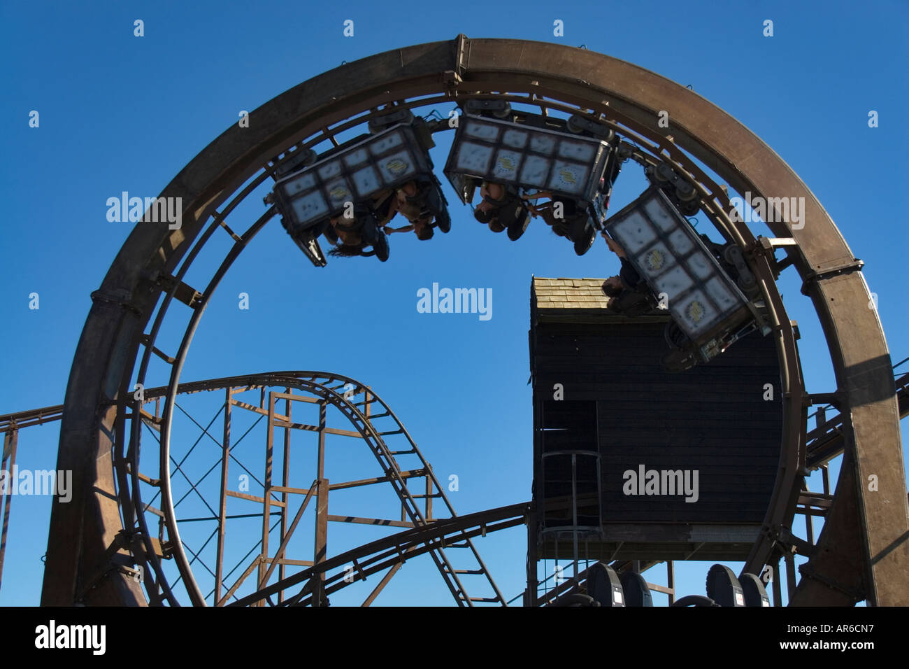 Children go upside down as they enjoy a roller coaster ride at a ...