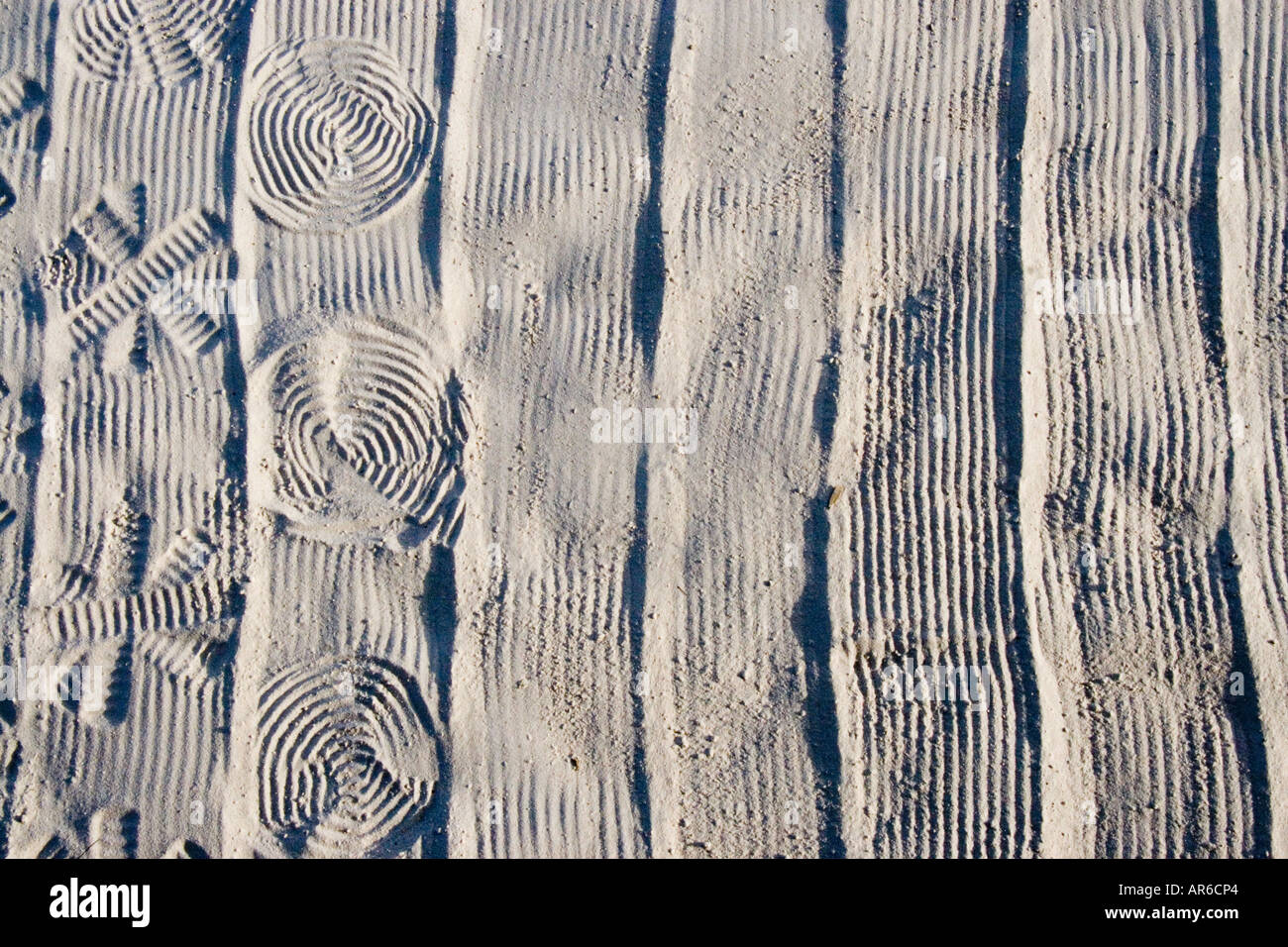 an overhead plan view of abstract patterns made in fine white sand with ...