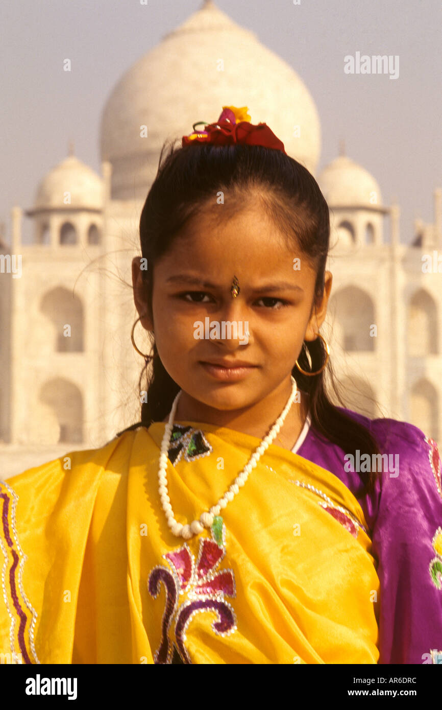 Wealthy young girl in expensive dress in front of the beautiful Taj ...